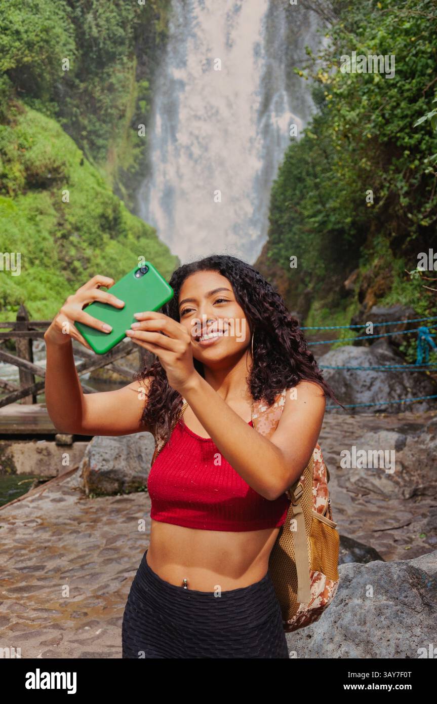 A joyful woman takes a moment to capture herself at a stunning ...