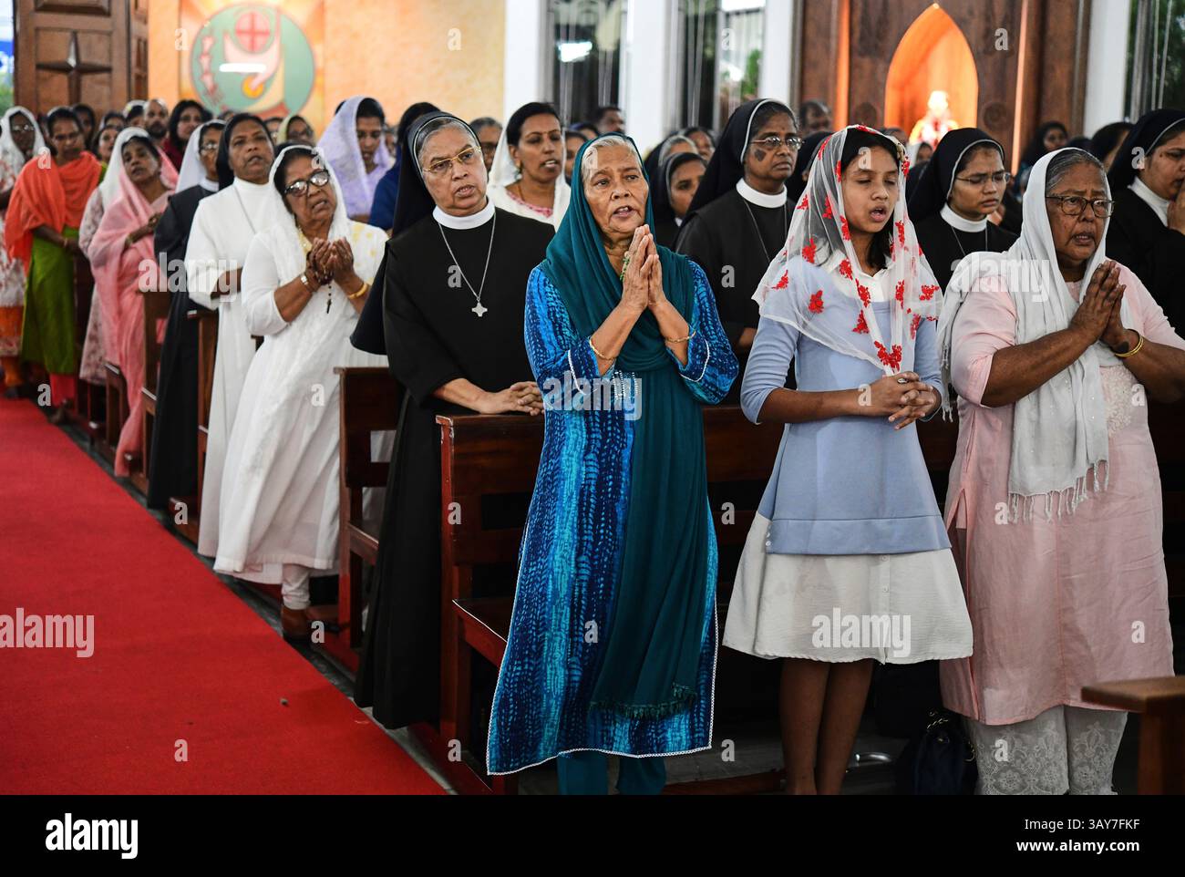 Indian Catholics pray during a requiem mass for the late Pope Francis ...