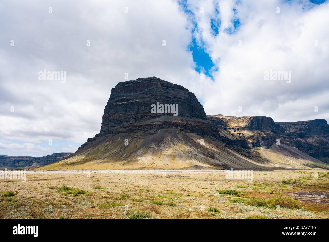 Isolated flat-topped mountain in Iceland under a dramatic sky, with ...