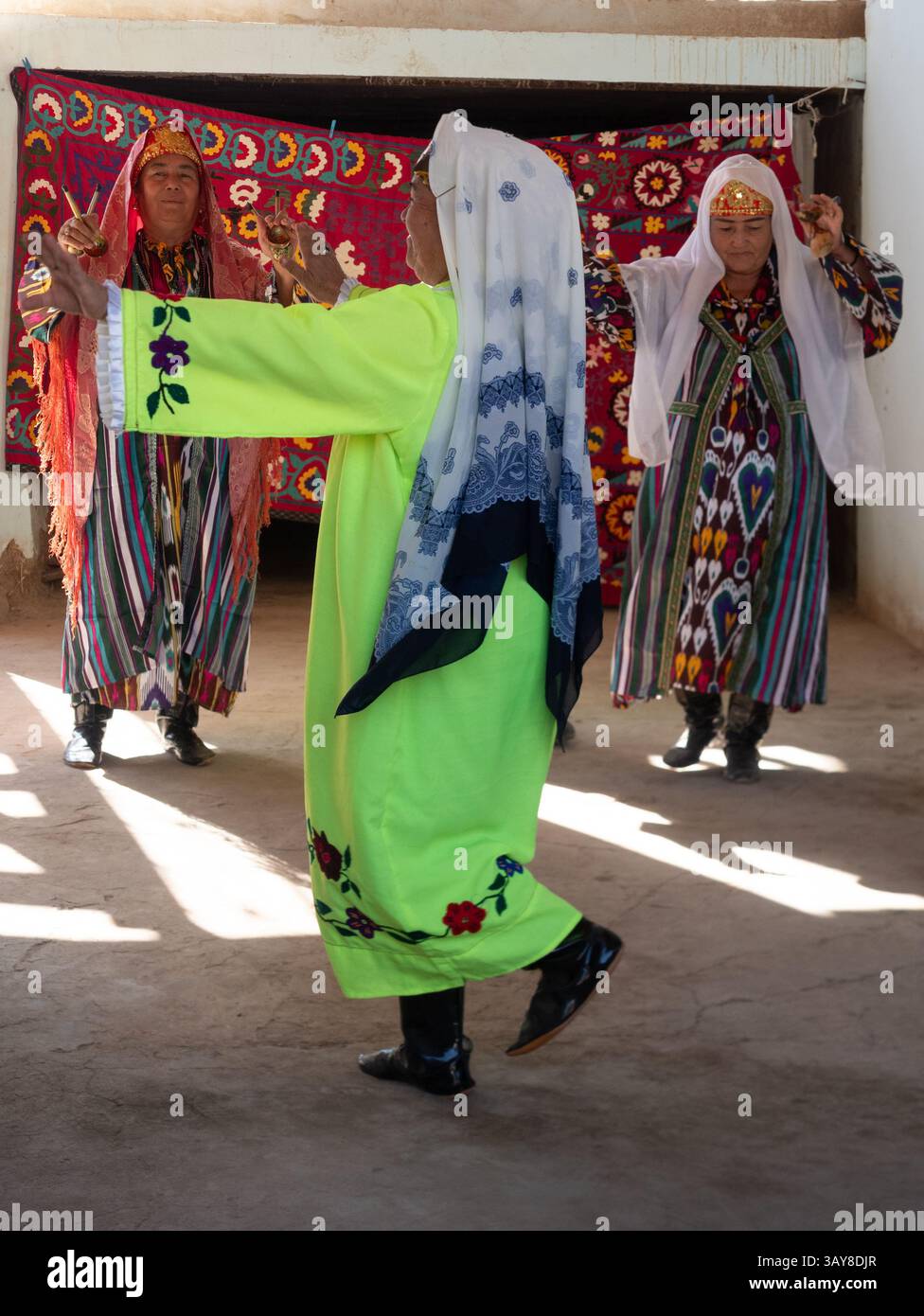 Three women wearing traditional garments and dancing in a folkloric ...