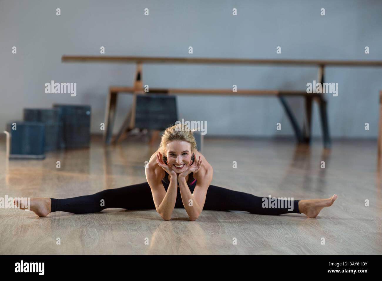 woman dancer performing straddle split in dance studio, with plyometric ...