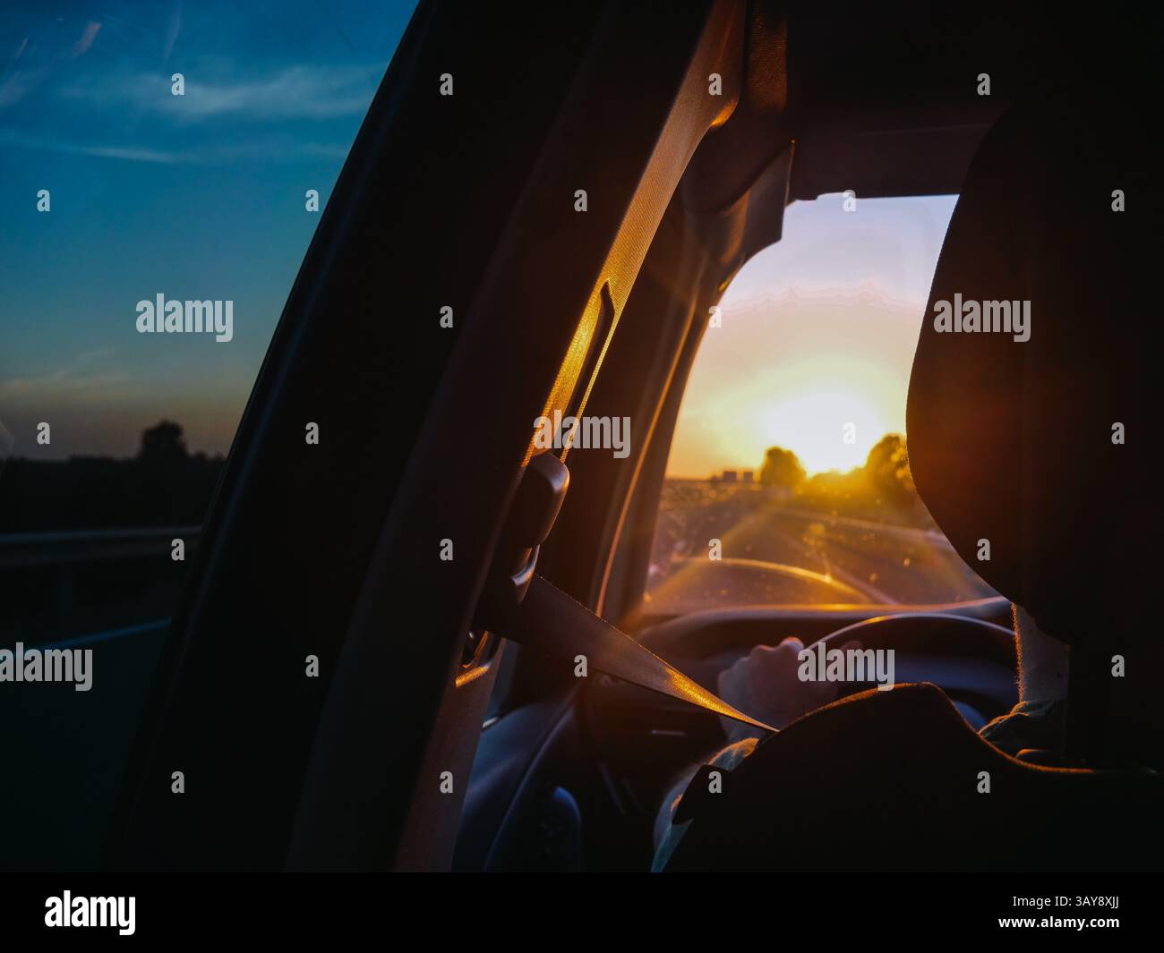 A view from the interior of a car, focusing on the drivers hands on the ...