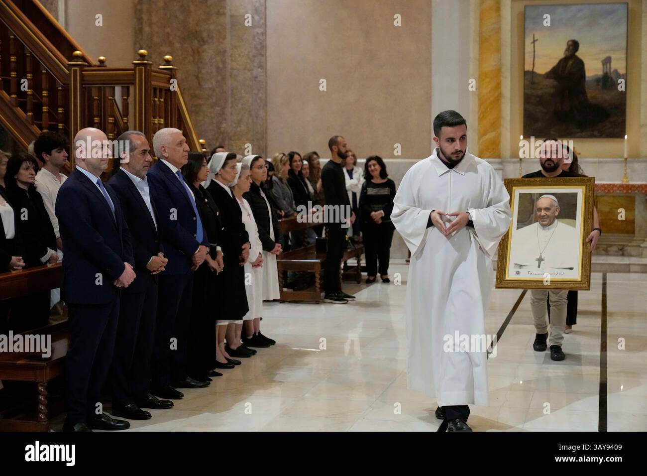 A priest and altar servers arrive for a requiem mass for the late Pope ...