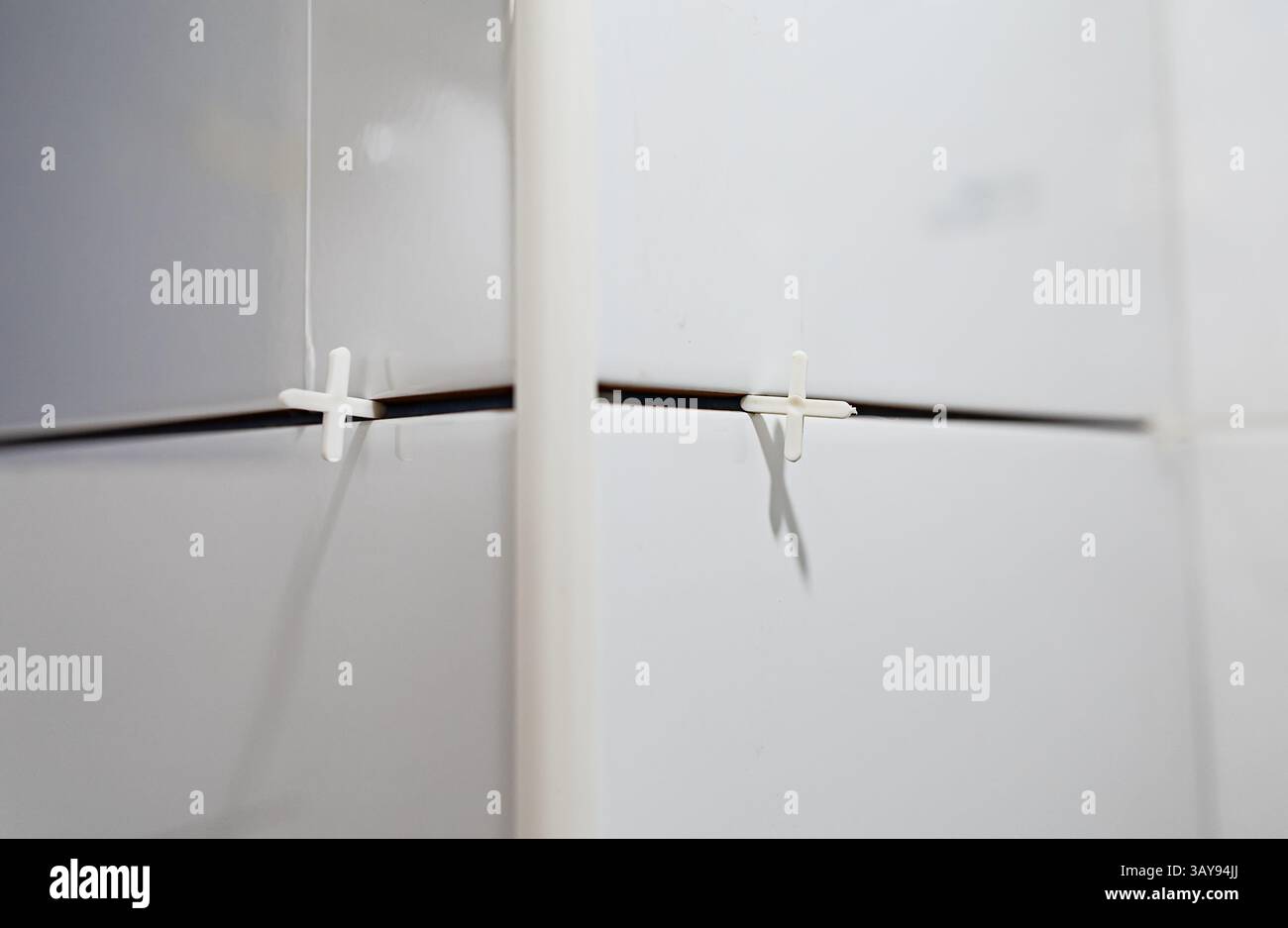 White Ceramic Tiles with Spacers Recently Installed on Wall Stock Photo ...