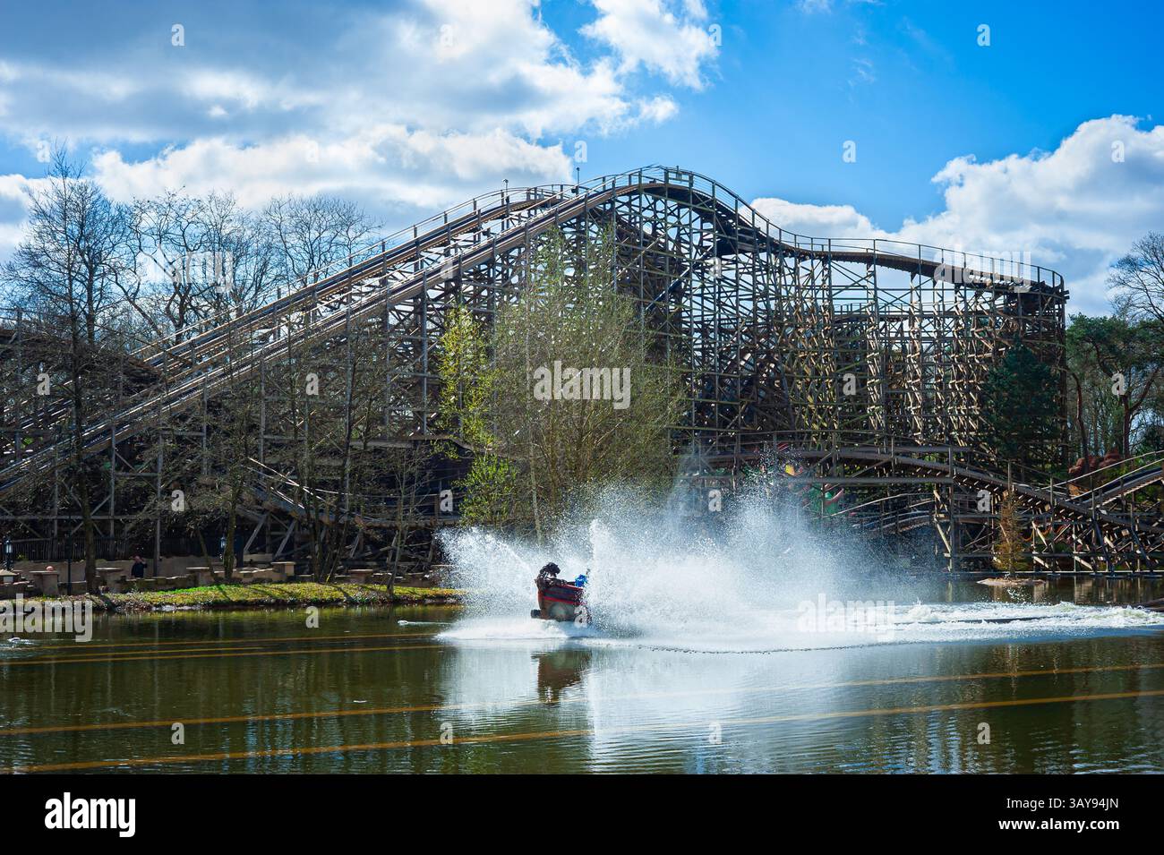 Wooden rollercoaster with vehicle that comes with a big splash into a ...
