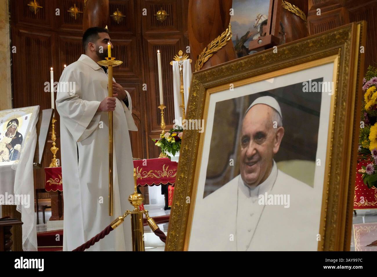 An altar server attends a requiem mass for the late Pope Francis, at ...