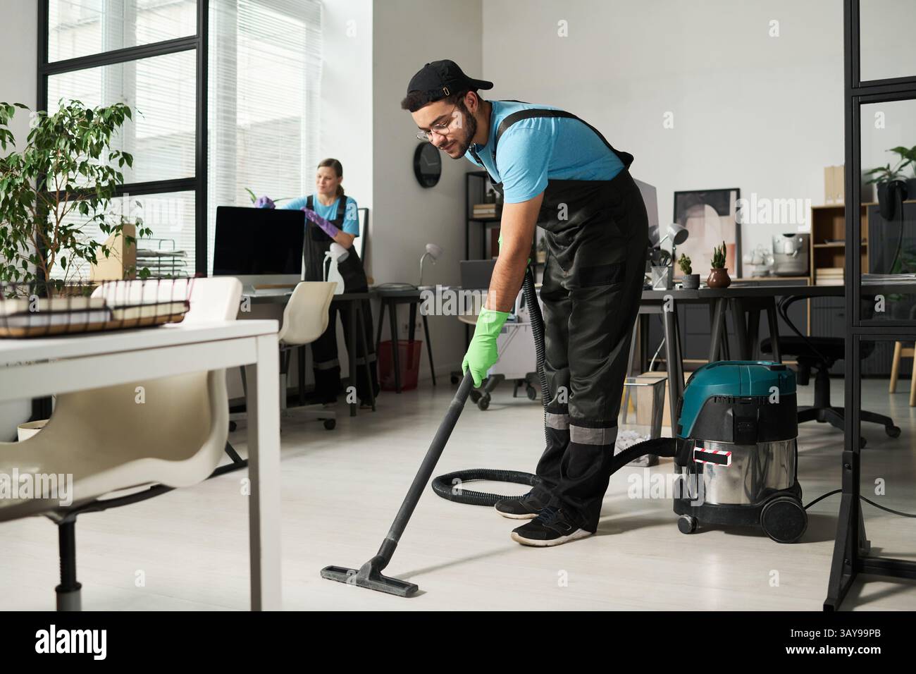 Man vacuuming office hi-res stock photography and images - Alamy