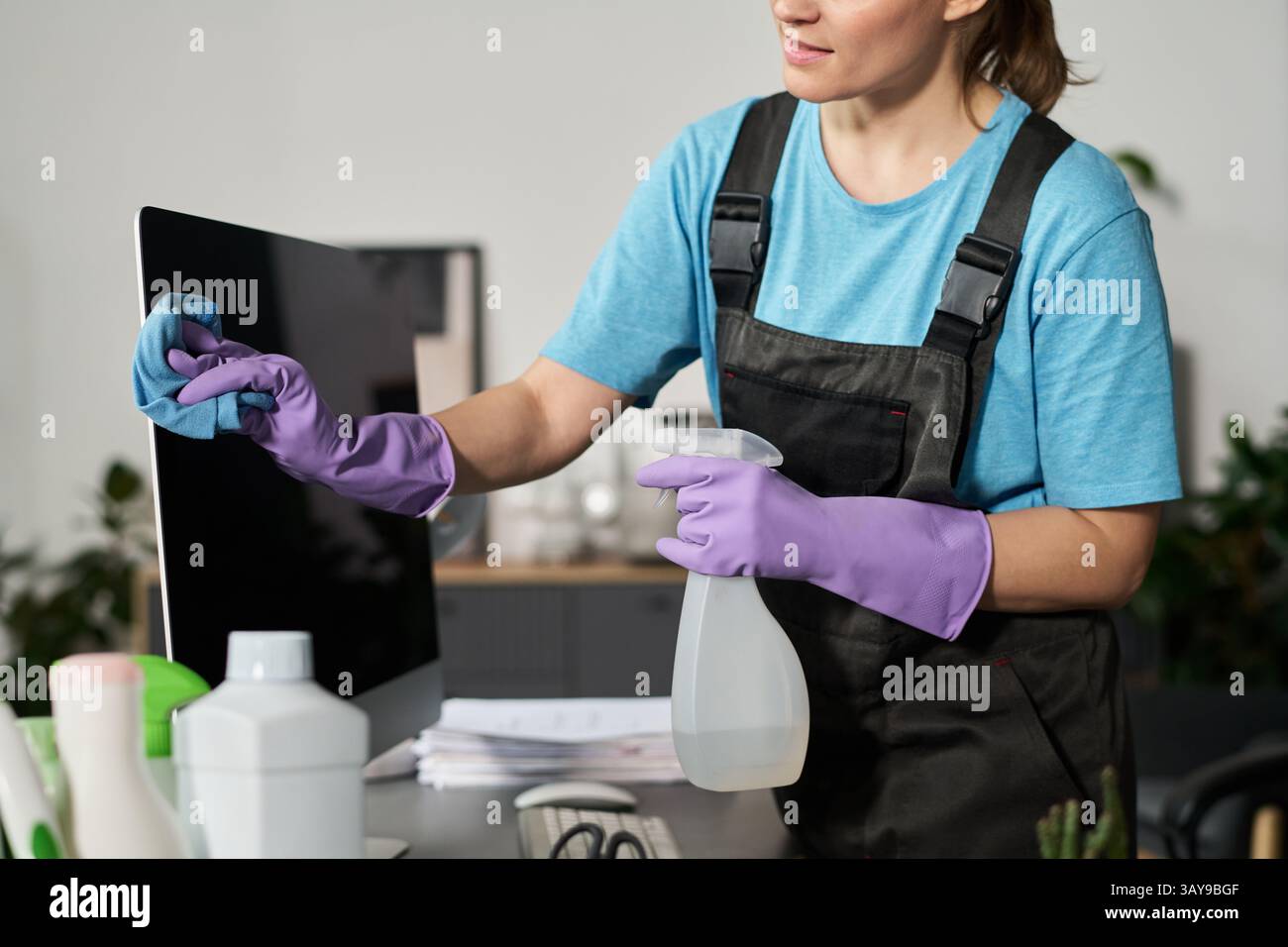 Woman Wiping Screen Of Computer During Cleaning Stock Photo - Alamy