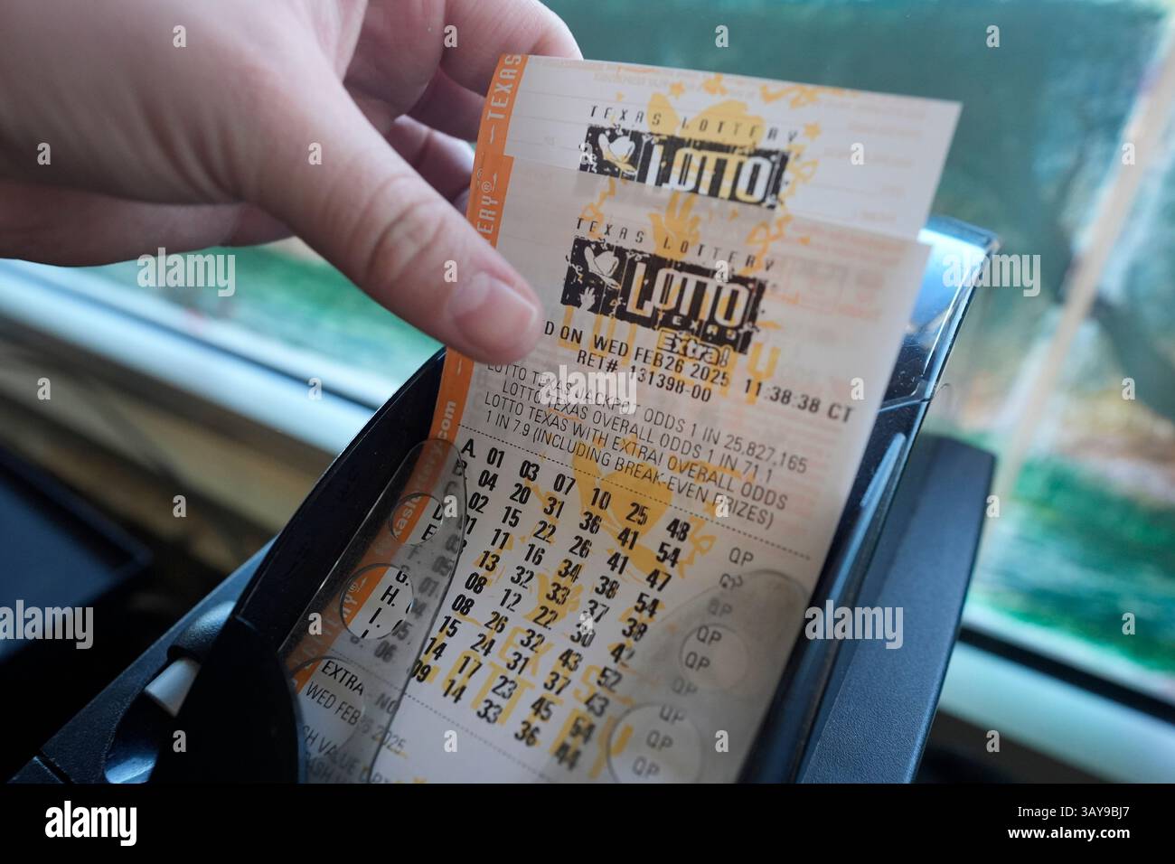 FILE - Edith Patlan grabs printed tickets from a Texas Lottery sales ...