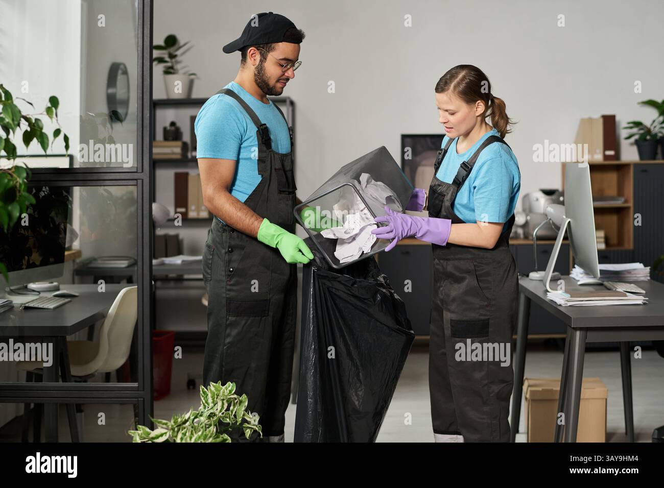 Cleaning Workers Throwing Garbage During Work In Office Stock Photo - Alamy