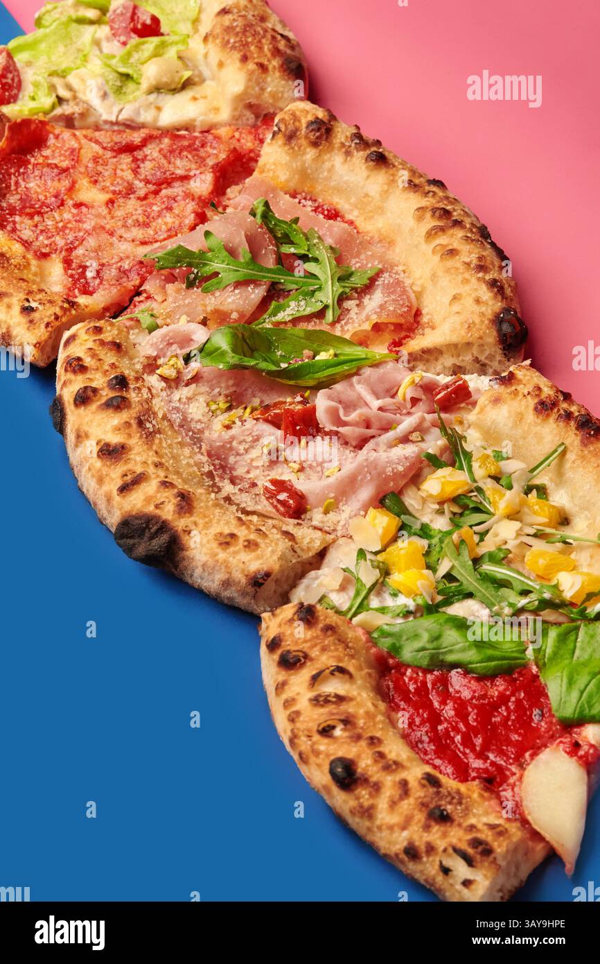 Gourmet pizza slices with various toppings on colorful background Stock ...