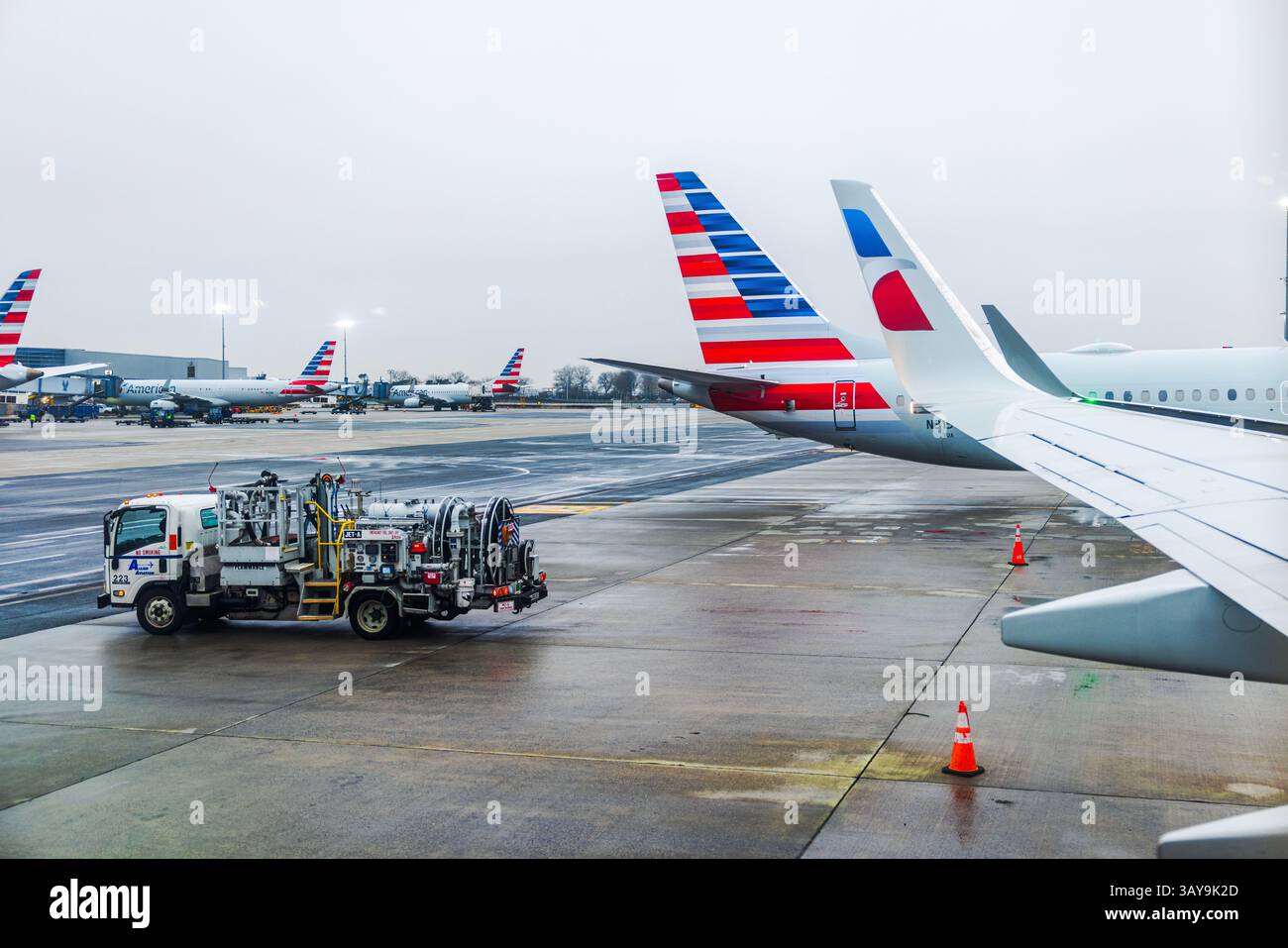 Ground support vehicle parked near multiple planes with visible ...