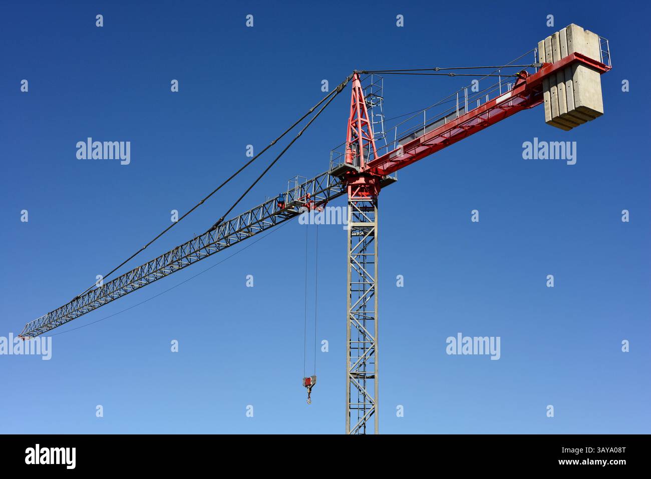 Unbranded tower crane against cloudless blue sky, construction ...