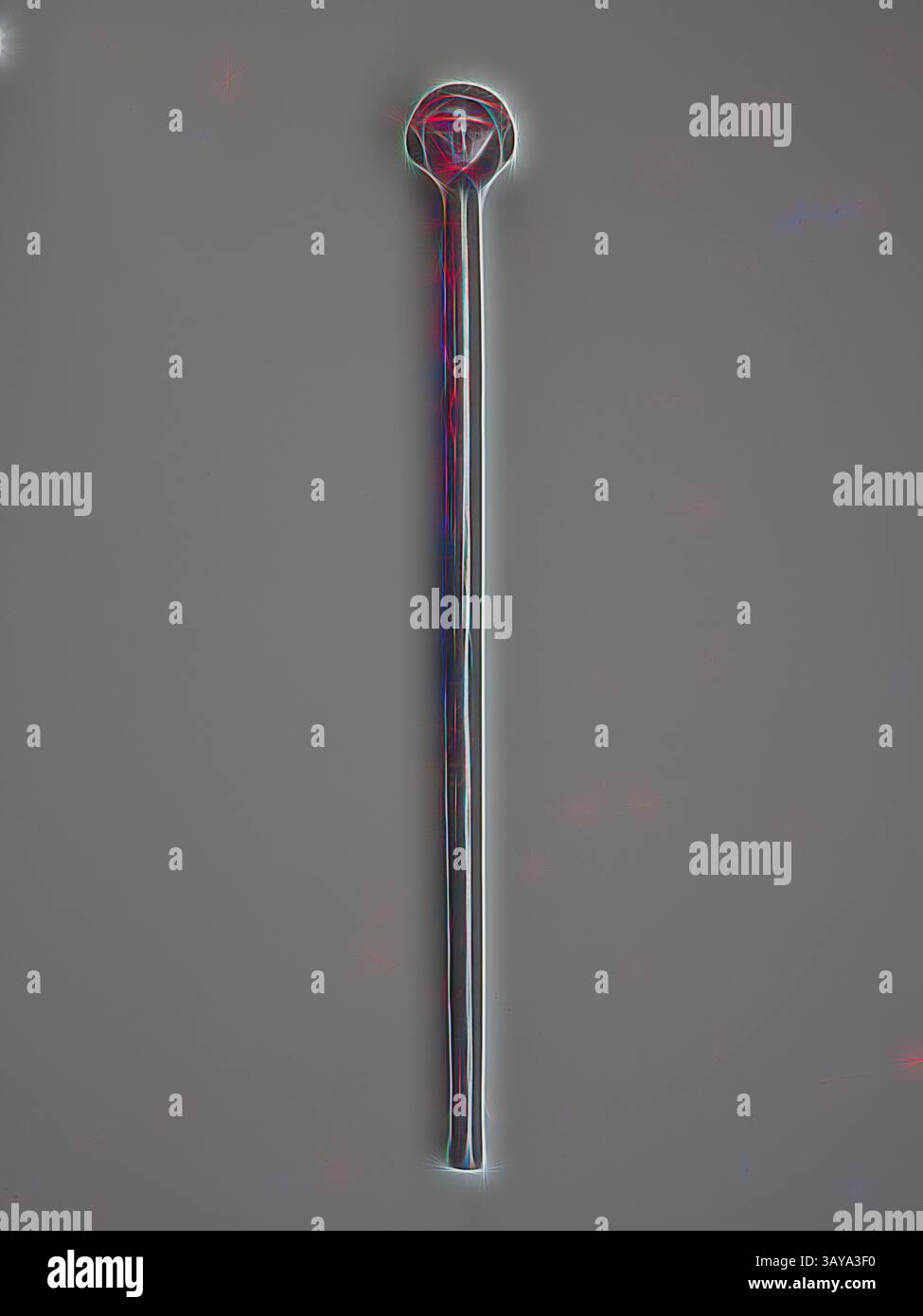 A long, slender stick topped with a spherical end, displaying a soft ...