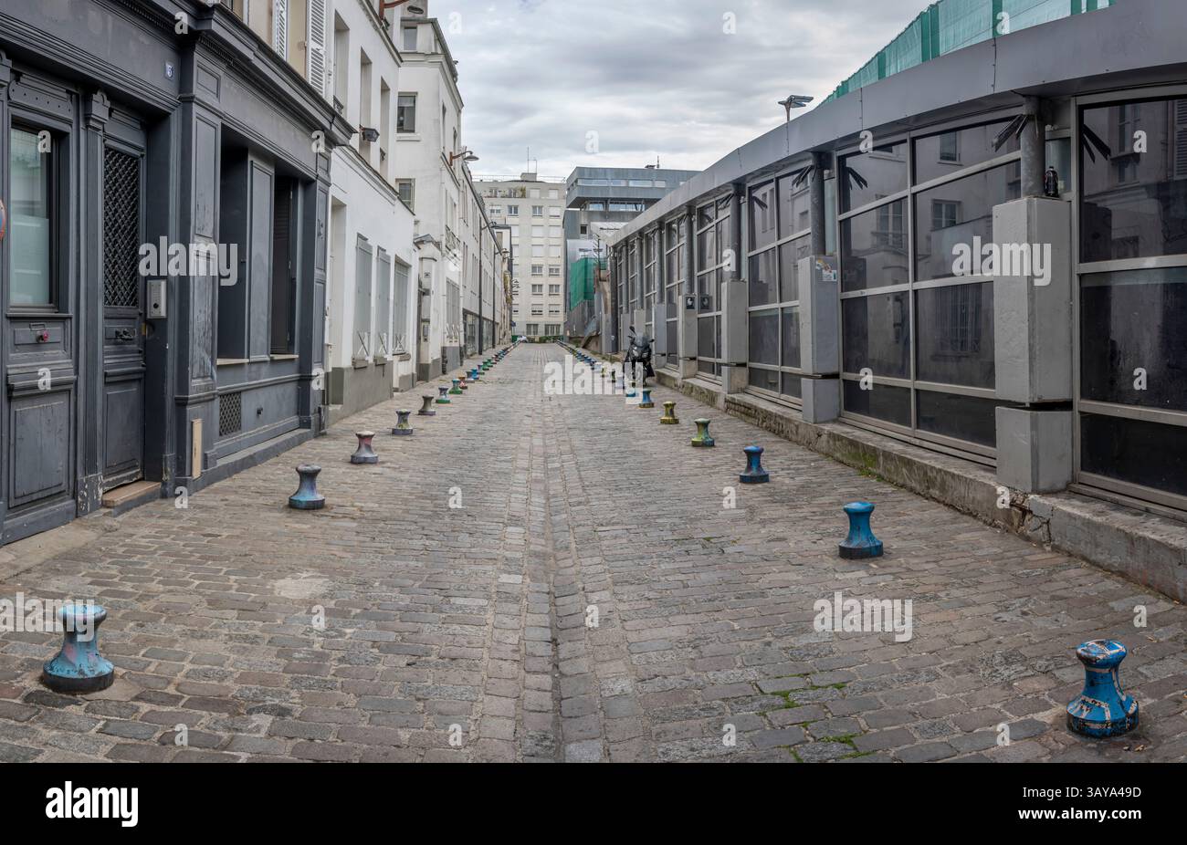 Paris, France - 04 19 2025: View of a typical cobbled alley with ...