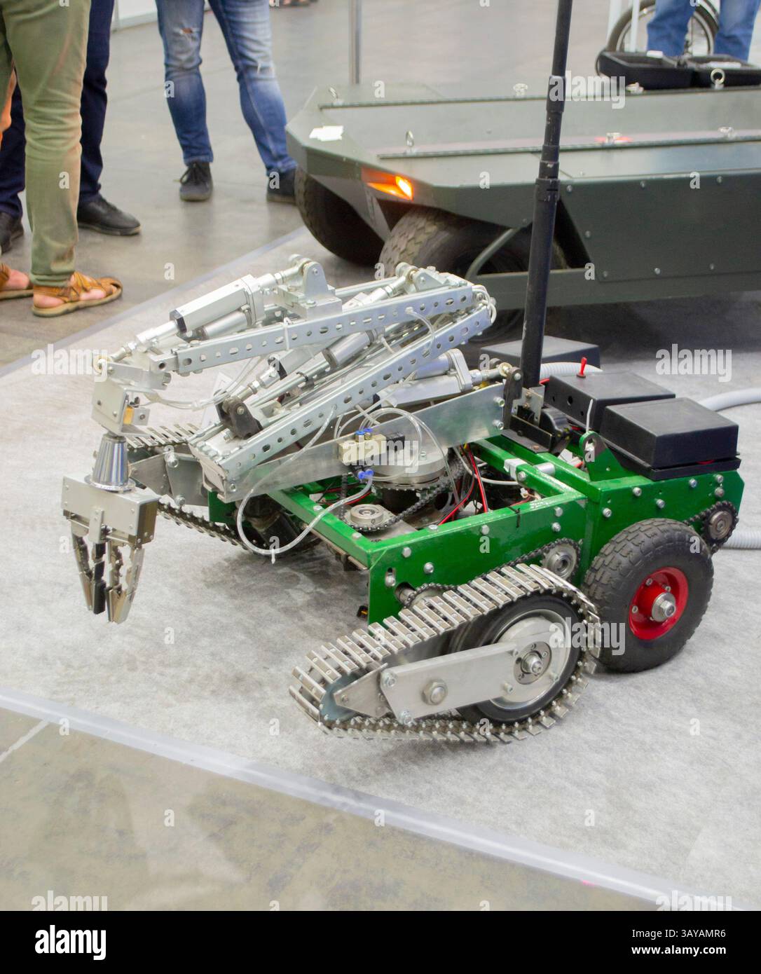 Small robot car unmanned with a crane and on tracks. Robotization ...
