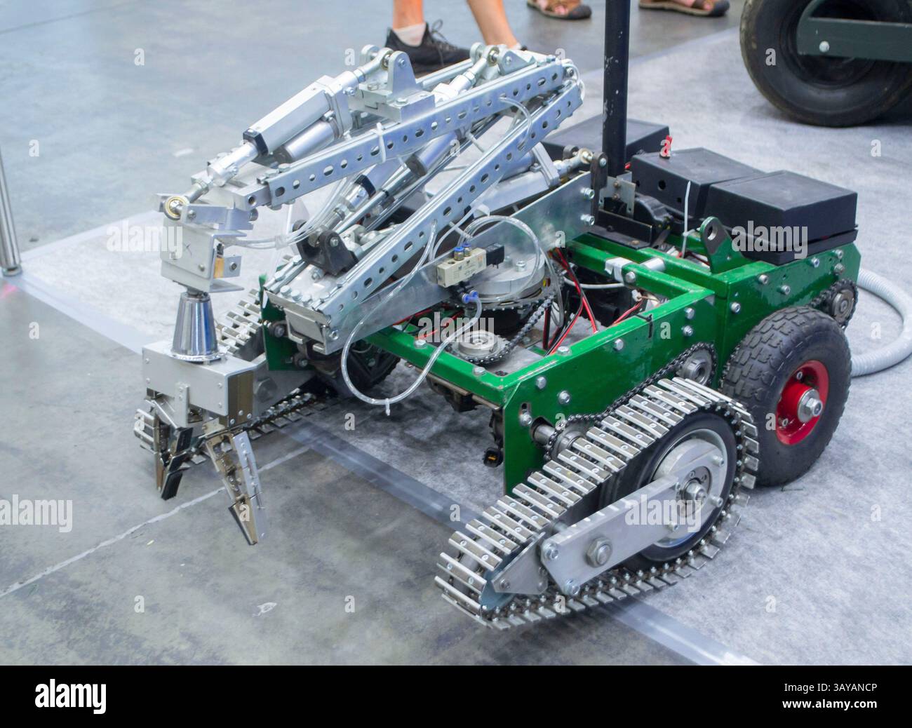 Small robot car unmanned with a crane and on tracks. Robotization ...