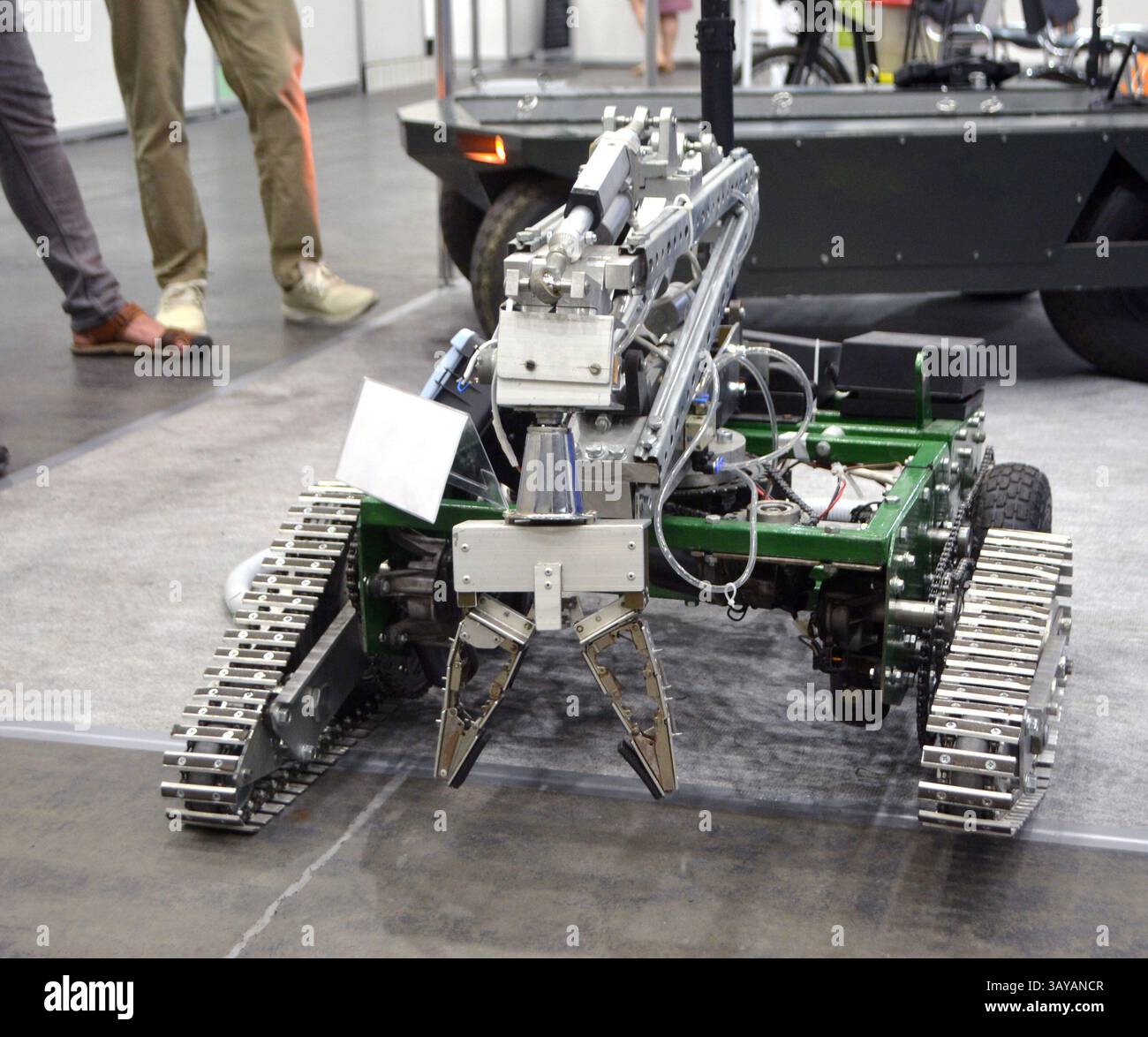 Small robot car unmanned with a crane and on tracks. Robotization ...
