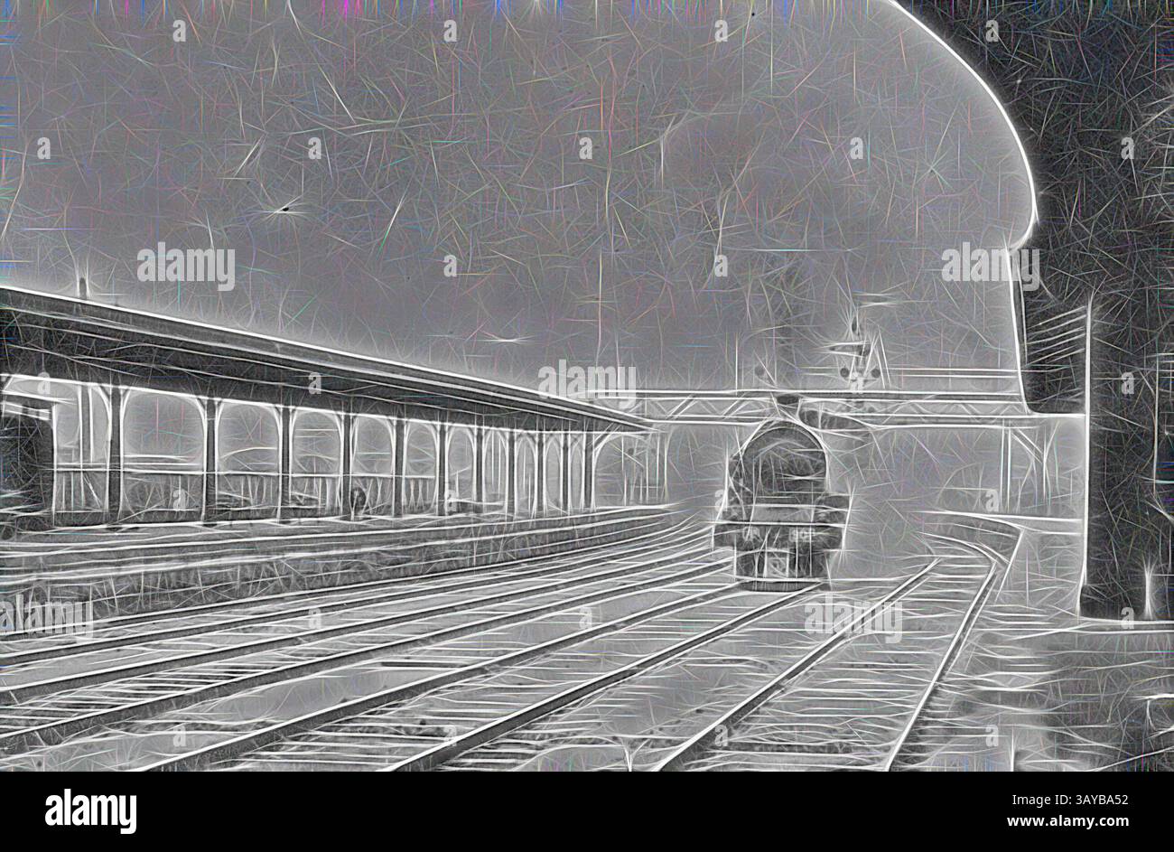 An old train station with tracks leading towards an ornate platform ...