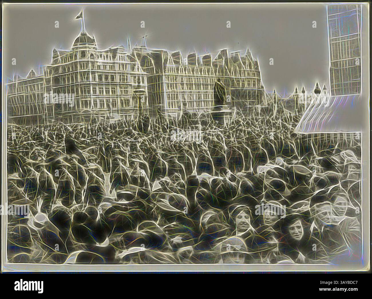 A large crowd gathers in a bustling square, with historic buildings in ...