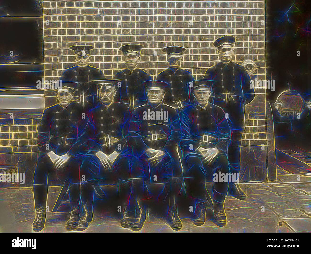 A group of eight uniformed officers poses together, seated in front of ...