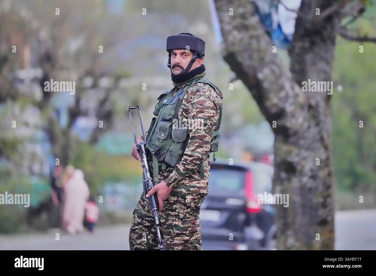 An Indian security officer stands guard in south Kashmir after ...