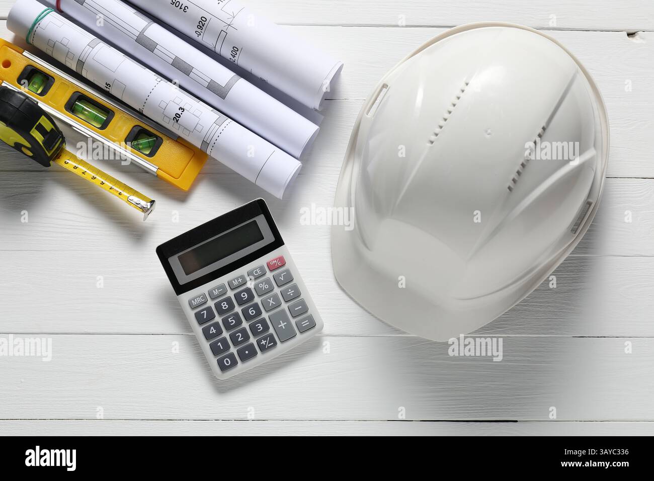Different technical drawings, hard hat, calculator, building level and ...