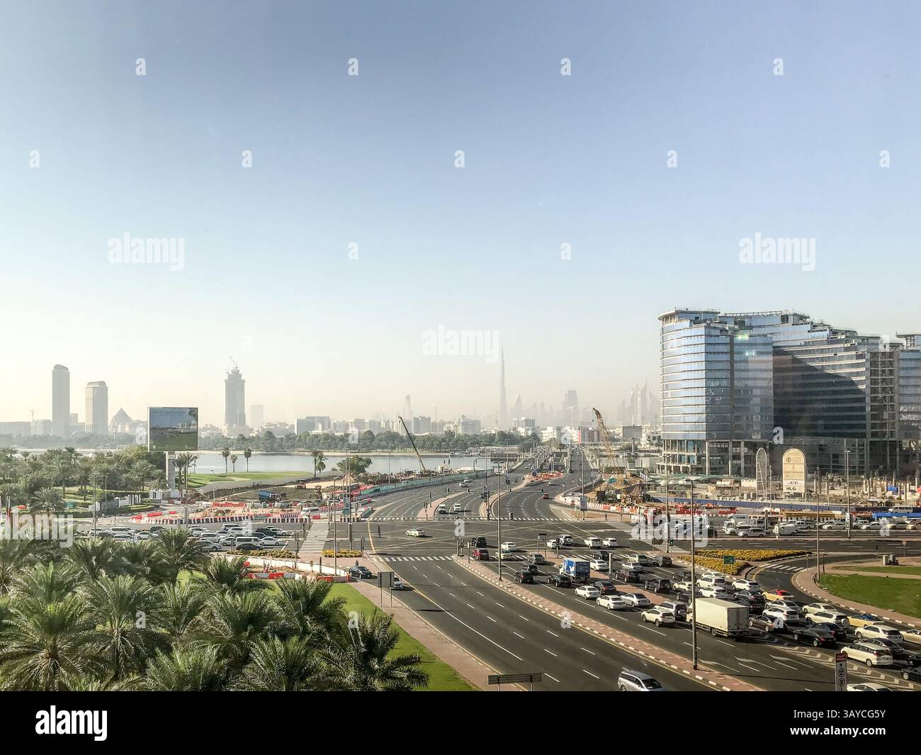 The dynamic skyline of Dubai, featuring a bustling road lined with palm ...
