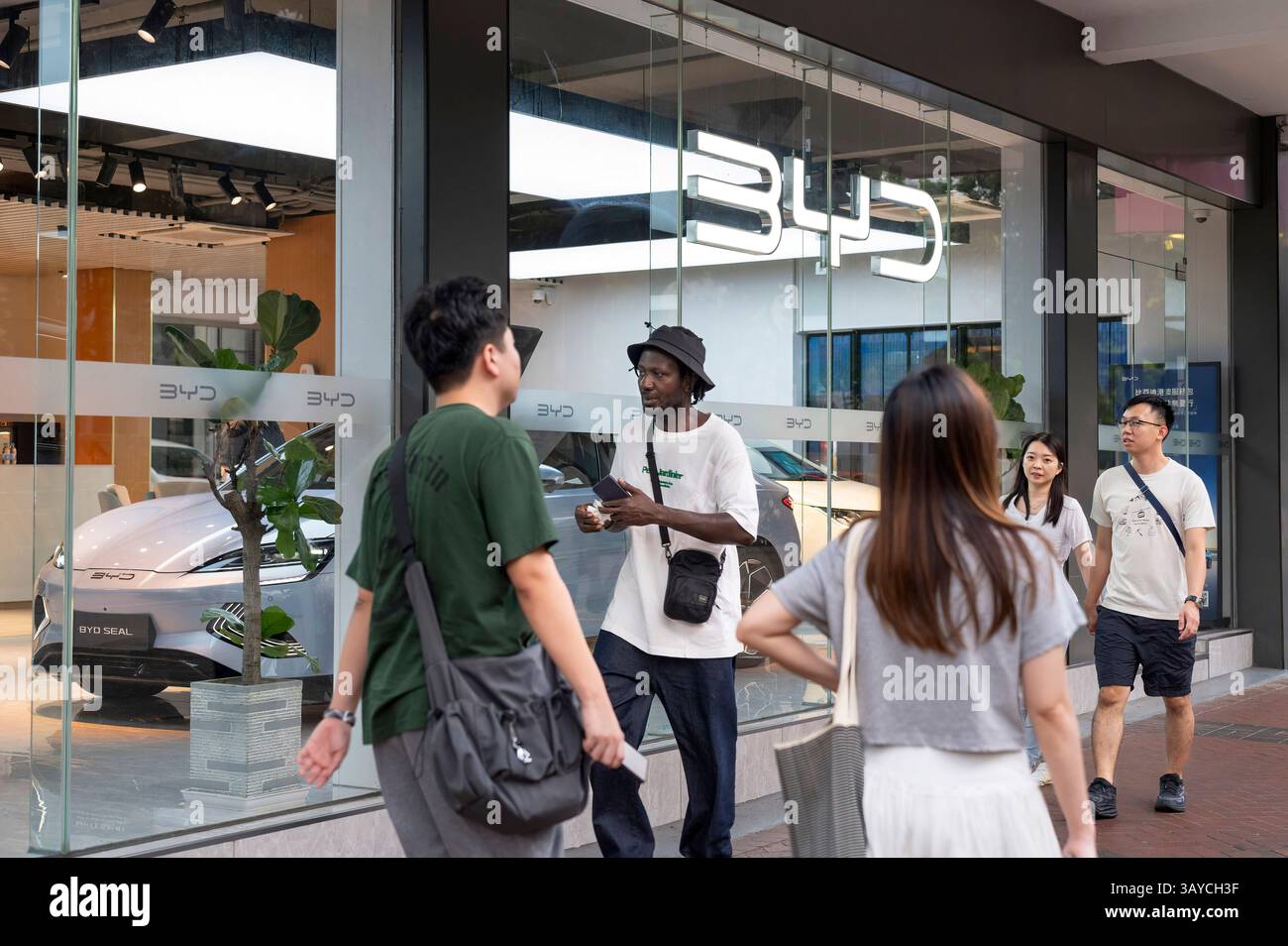 Pedestrians walk past the Chinese automaker BYD official authorized car ...