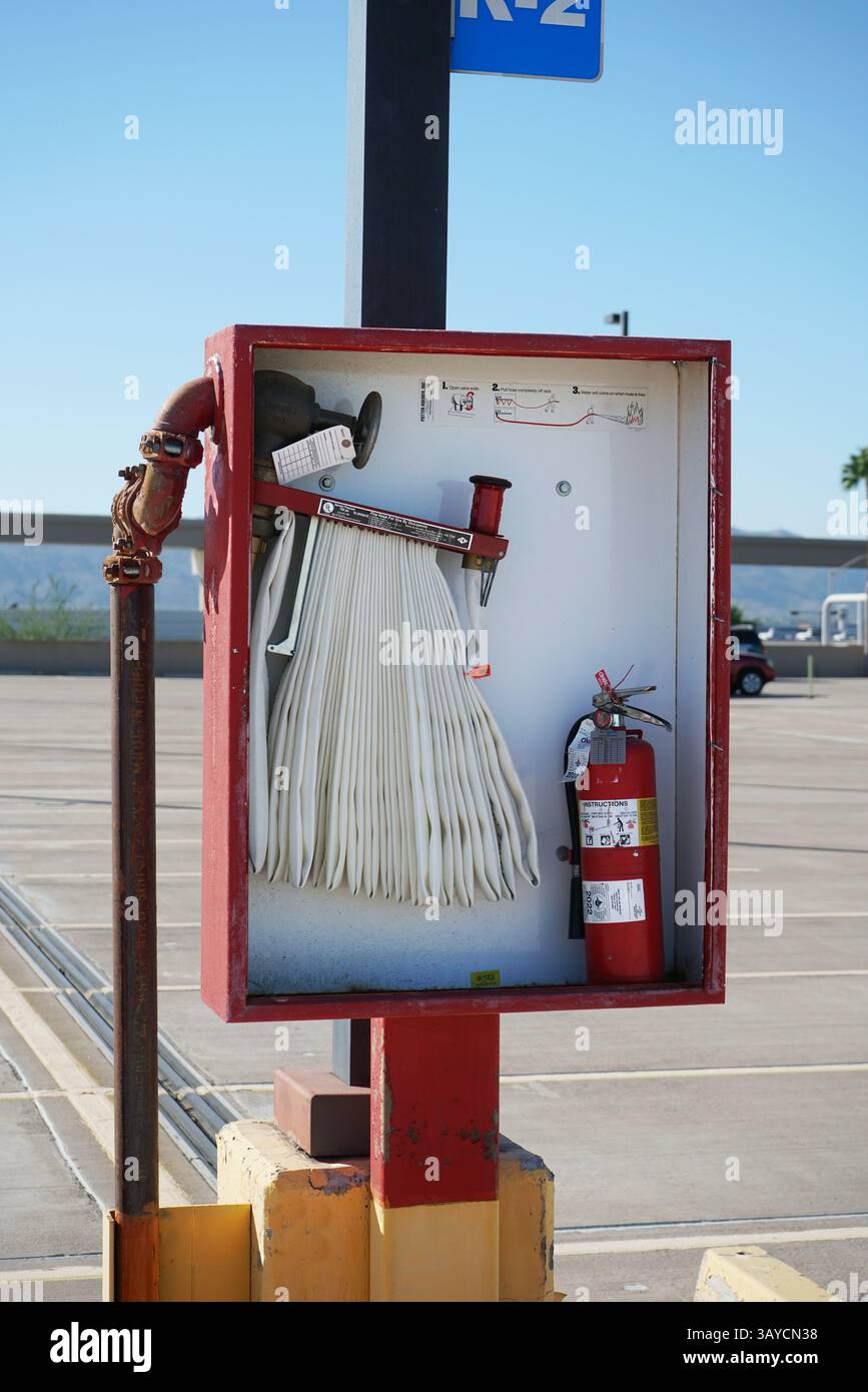 An emergency firehose and extinguisher station at public parking ...