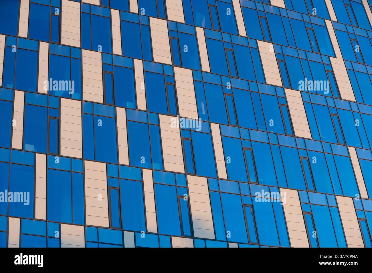 The facade of a contemporary building showcases striking blue glass ...