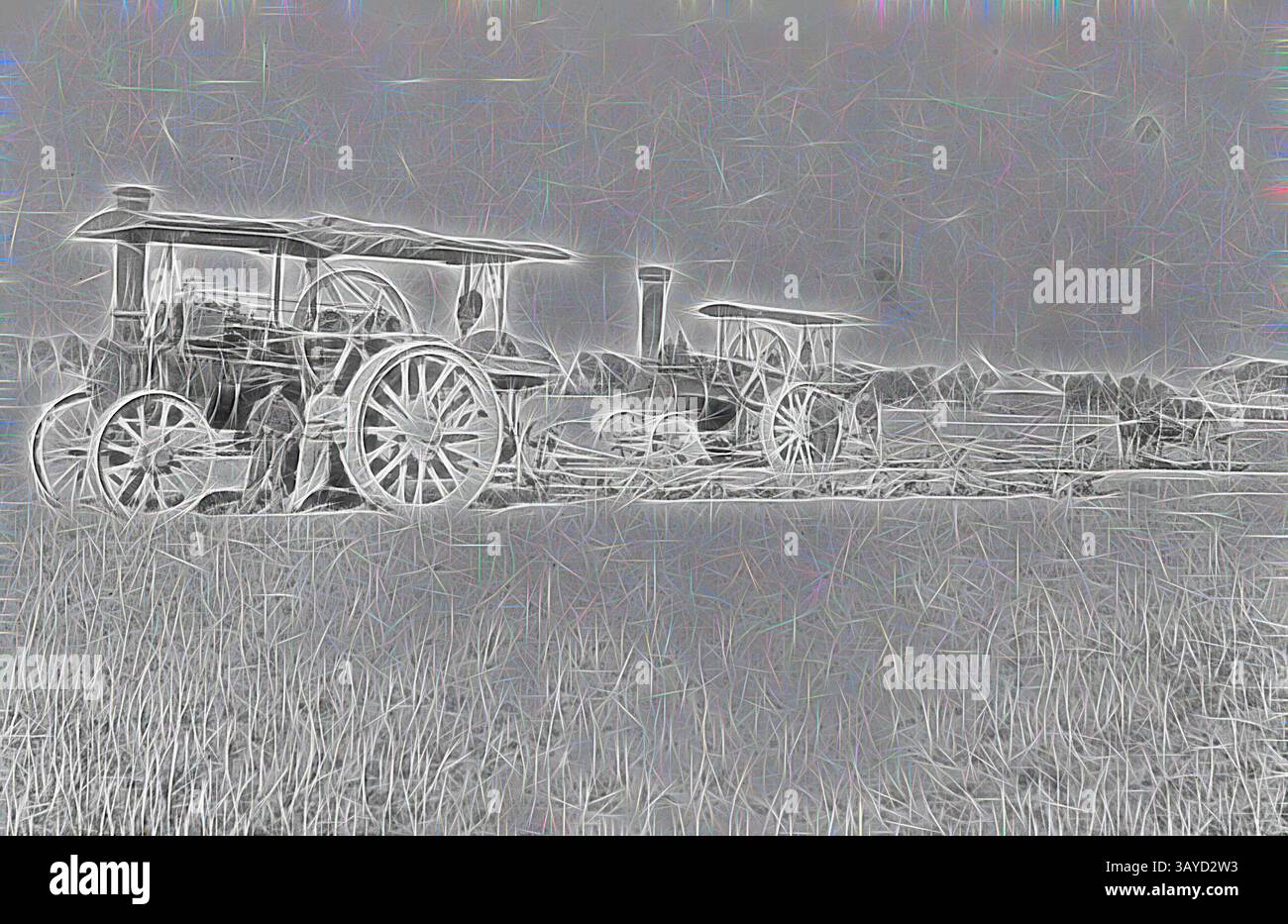 Two vintage steam engines stand side by side, their large wheels and ...