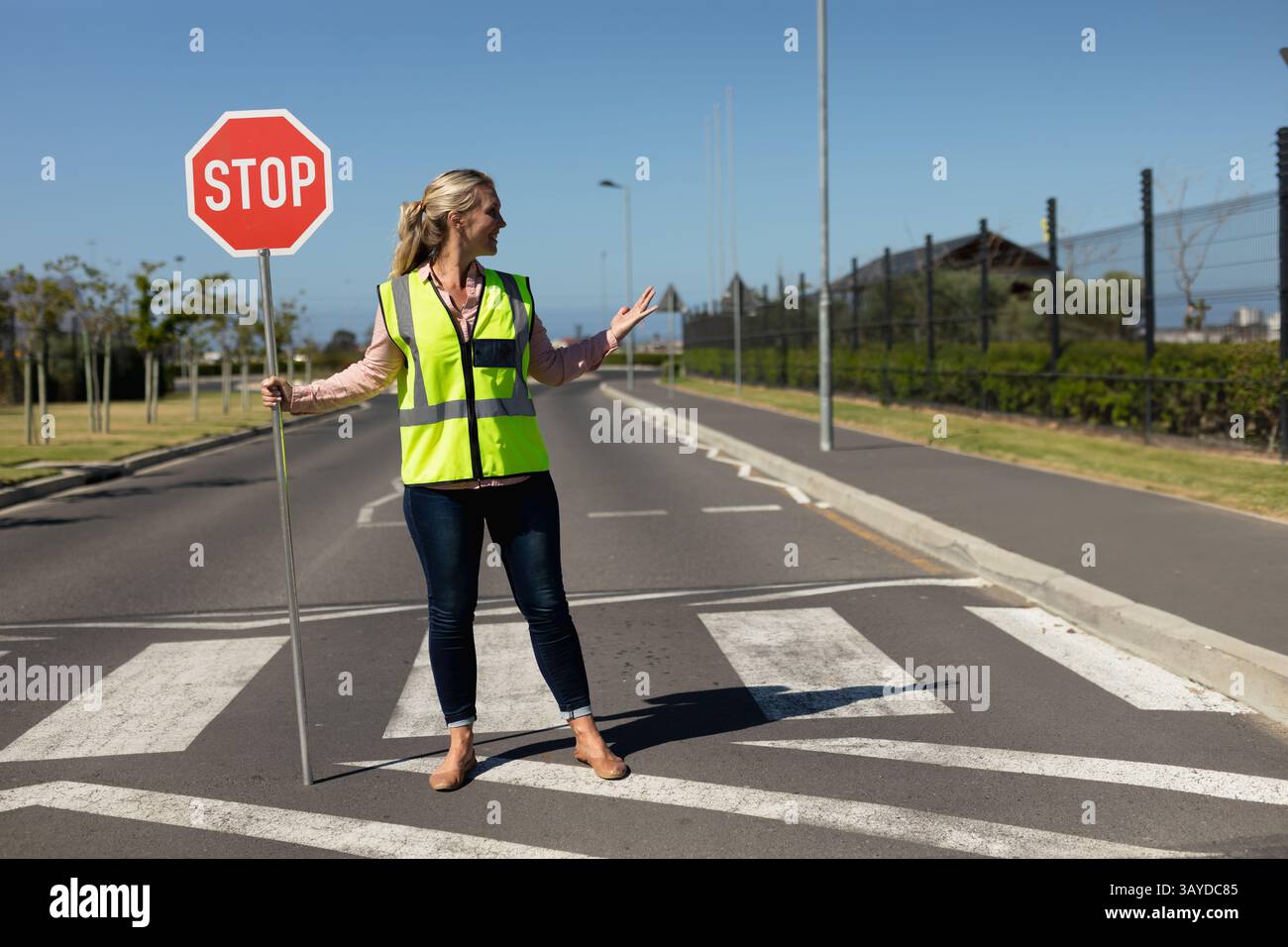 Crossing guard directing traffic near hi-res stock photography and ...