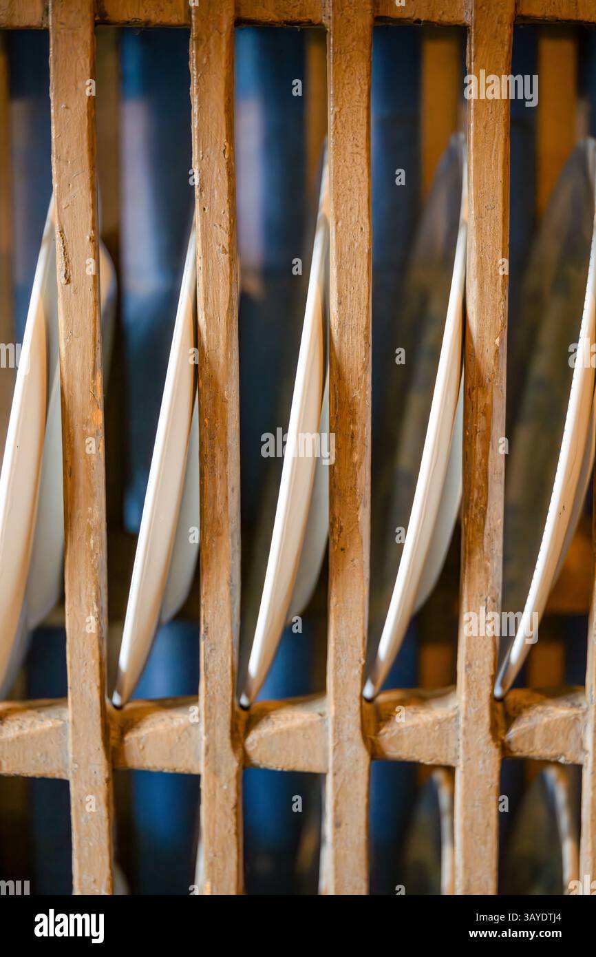 Vertical alignment of glazed ceramic plates nestled in a weathered ...