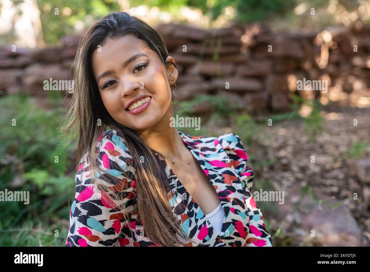 A cheerful and lively young woman poses gracefully and playfully amidst ...