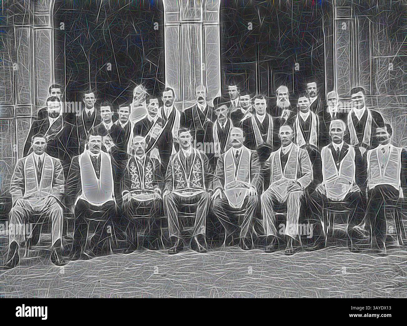 A large group of men dressed in formal attire, seated and standing in a ...