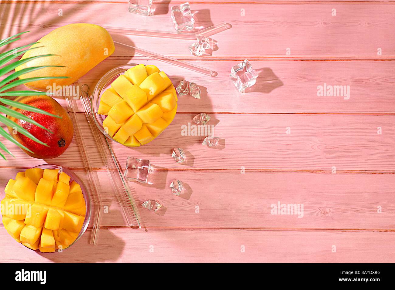 Summer party concept. Fresh red and light mango fruits and its slices ...