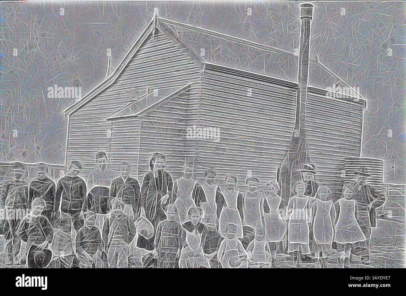A large group of people stands in front of a rustic wooden building ...