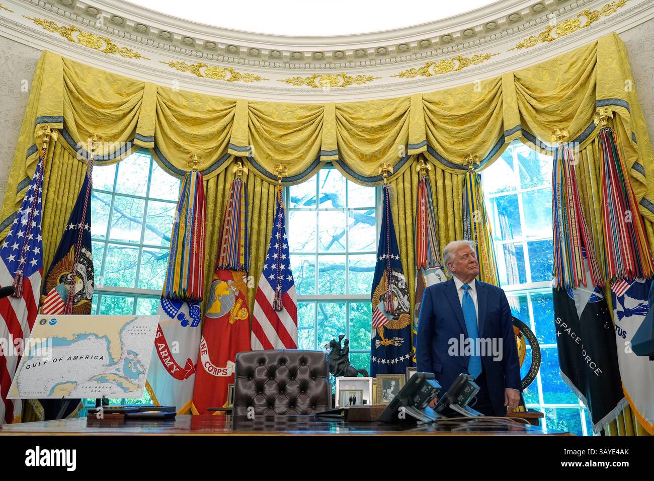President Donald Trump listens as Paul Atkins, chairman of the ...