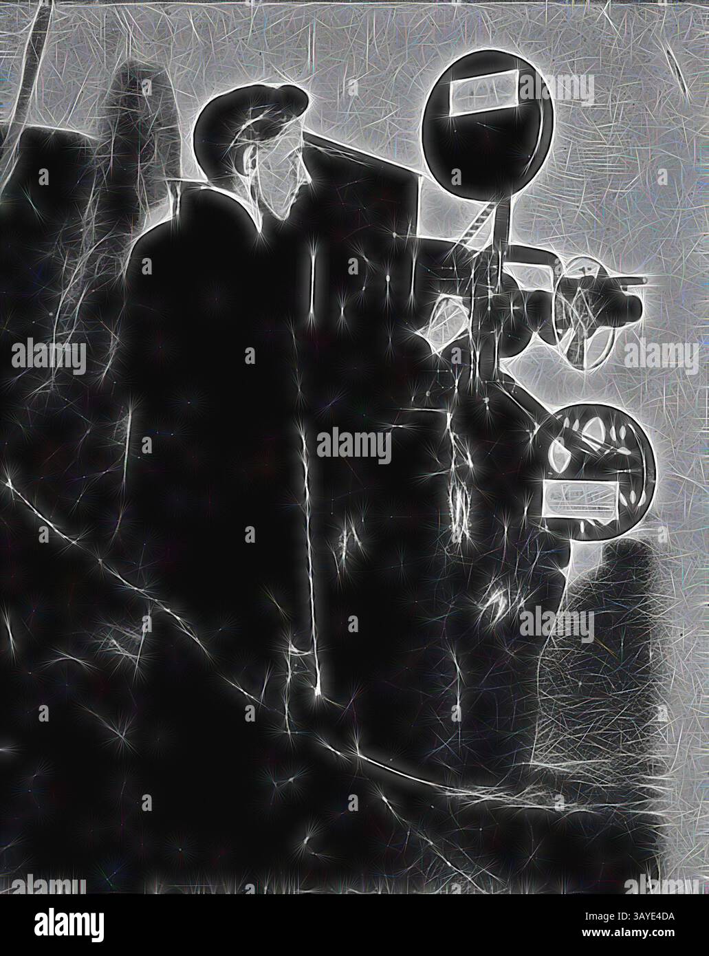 A figure stands beside a film projector, illuminated by soft light ...