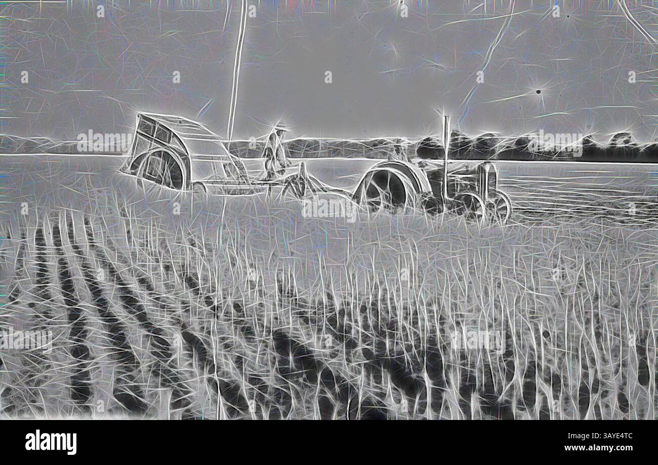 A vintage-looking tractor works its way through rows of freshly tilled ...