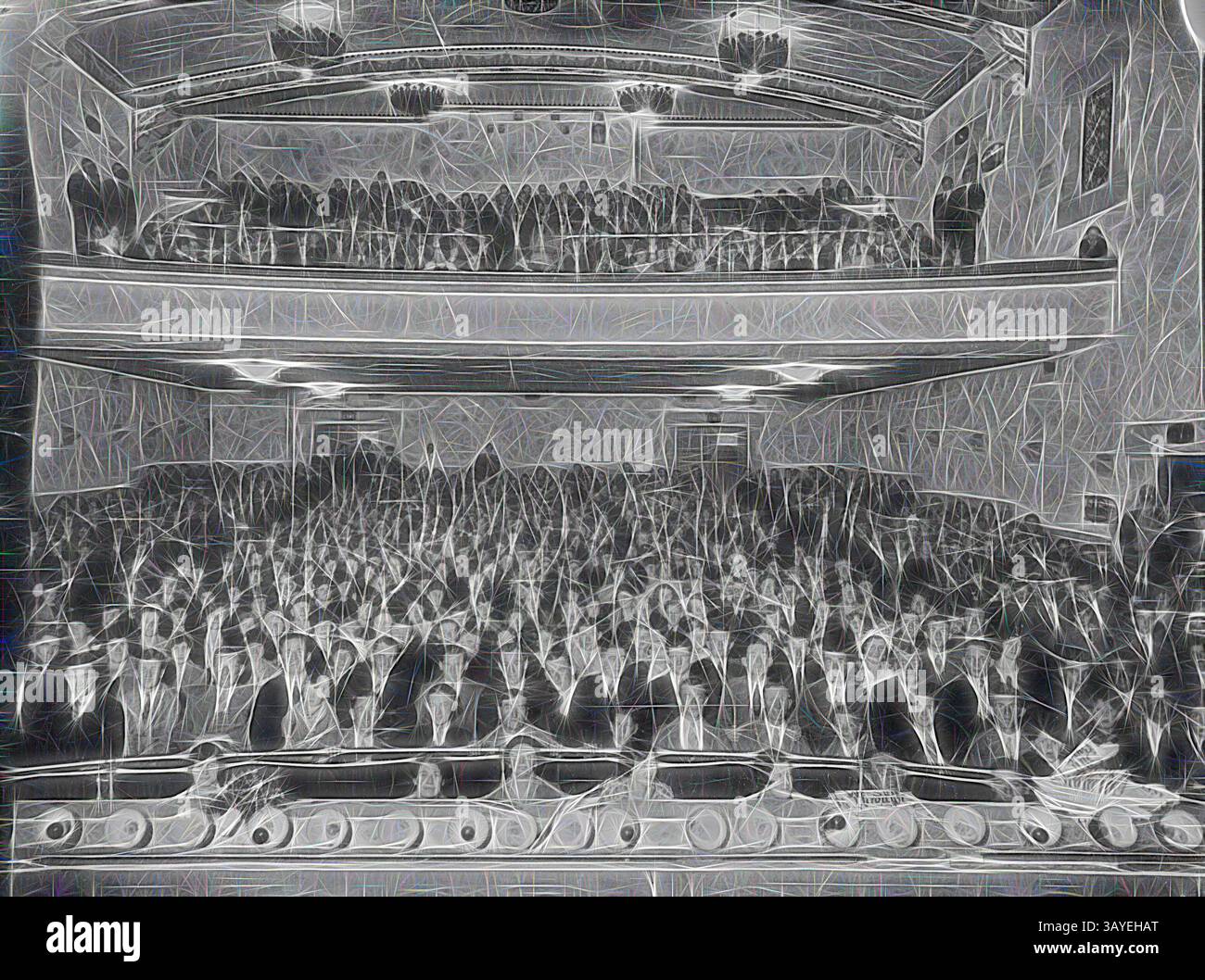A large audience fills a grand theater, seated in rows and attentively ...