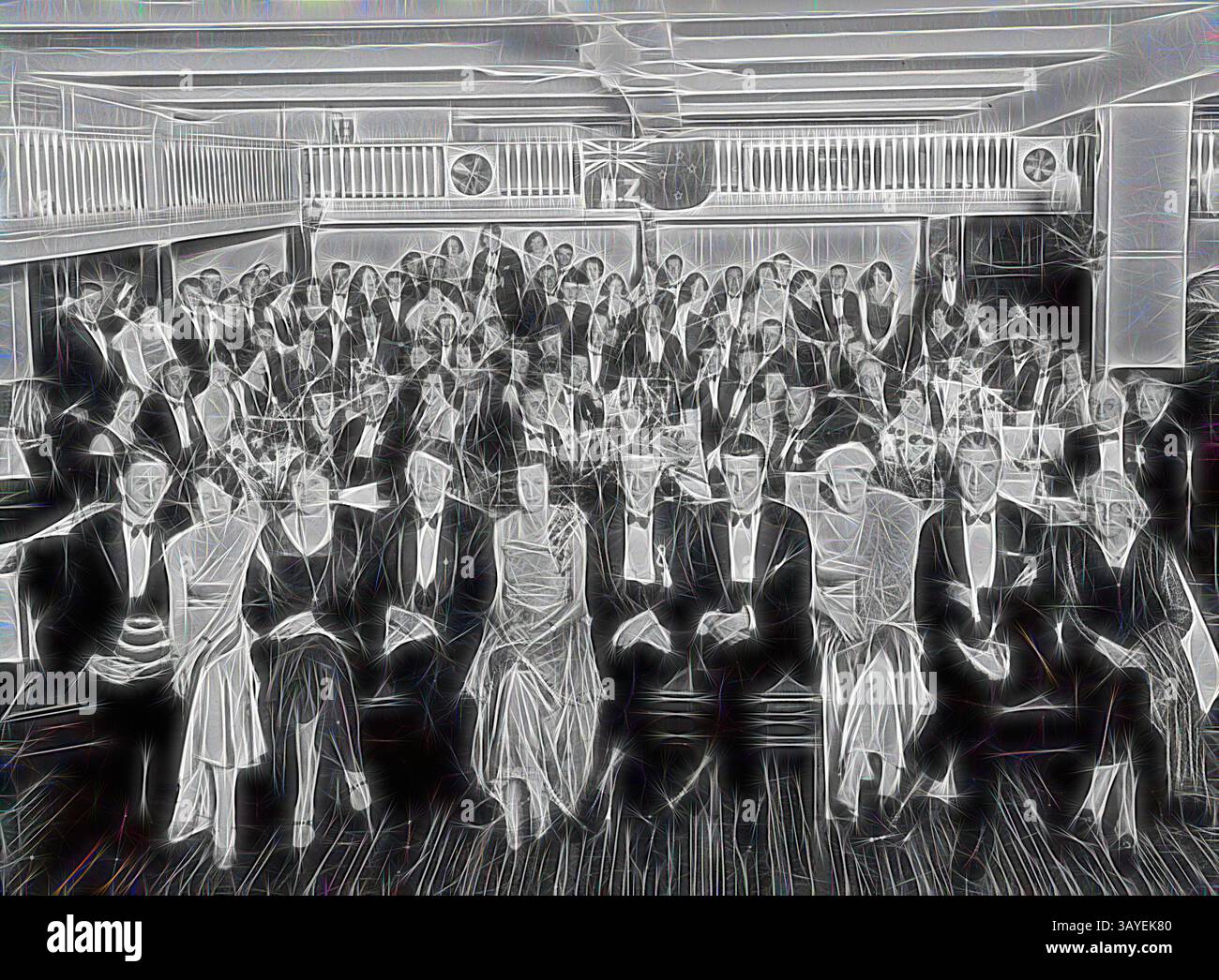 A large gathering of elegantly dressed individuals sits together in a ...