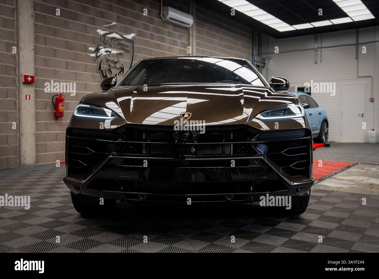 Close Up Front View of a Brown Lamborghini Urus in Indoor Setting Stock ...