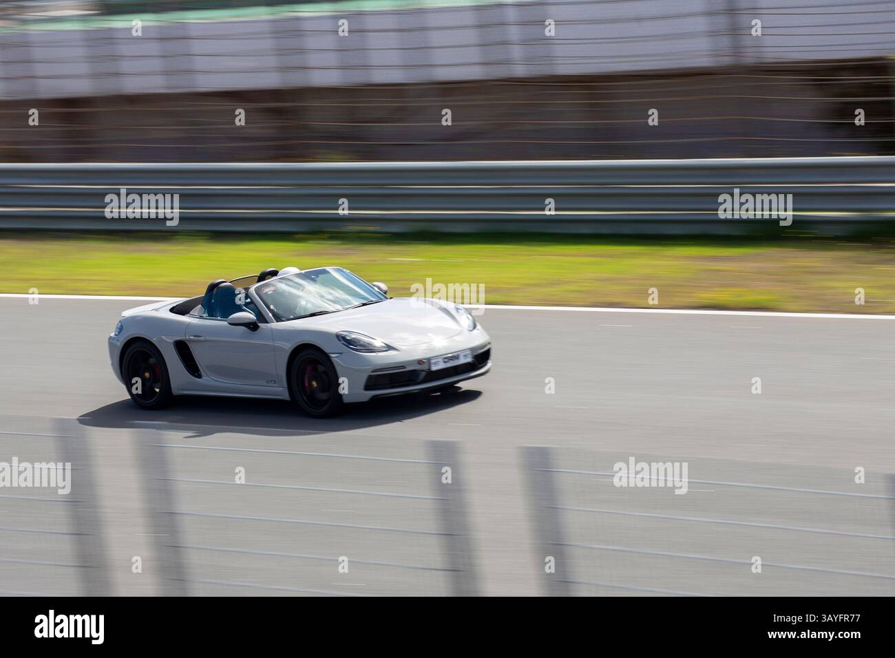 Silver Car Blazing Down the Track Stock Photo - Alamy