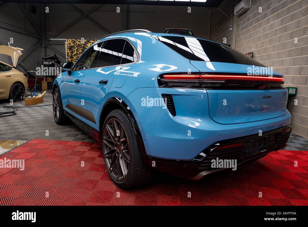 Close Up Rear View of Blue Porsche Macan in Workshop Setting Stock ...