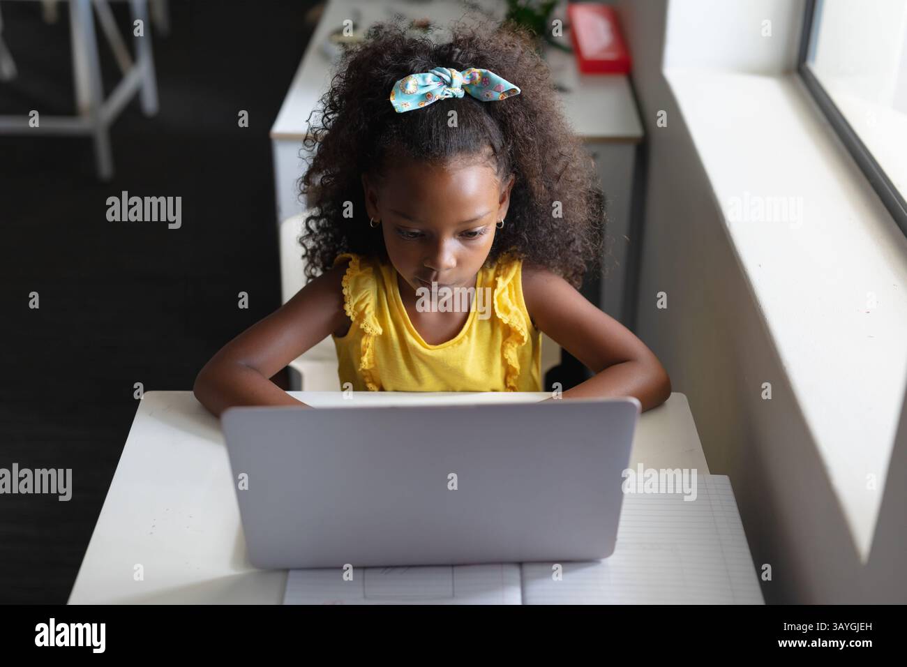 Child using silver laptop hi-res stock photography and images - Alamy