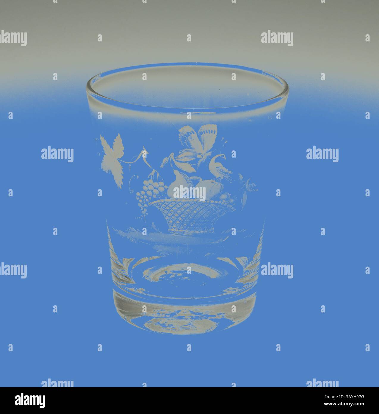 A beautifully etched glass featuring an intricate design of fruit and ...