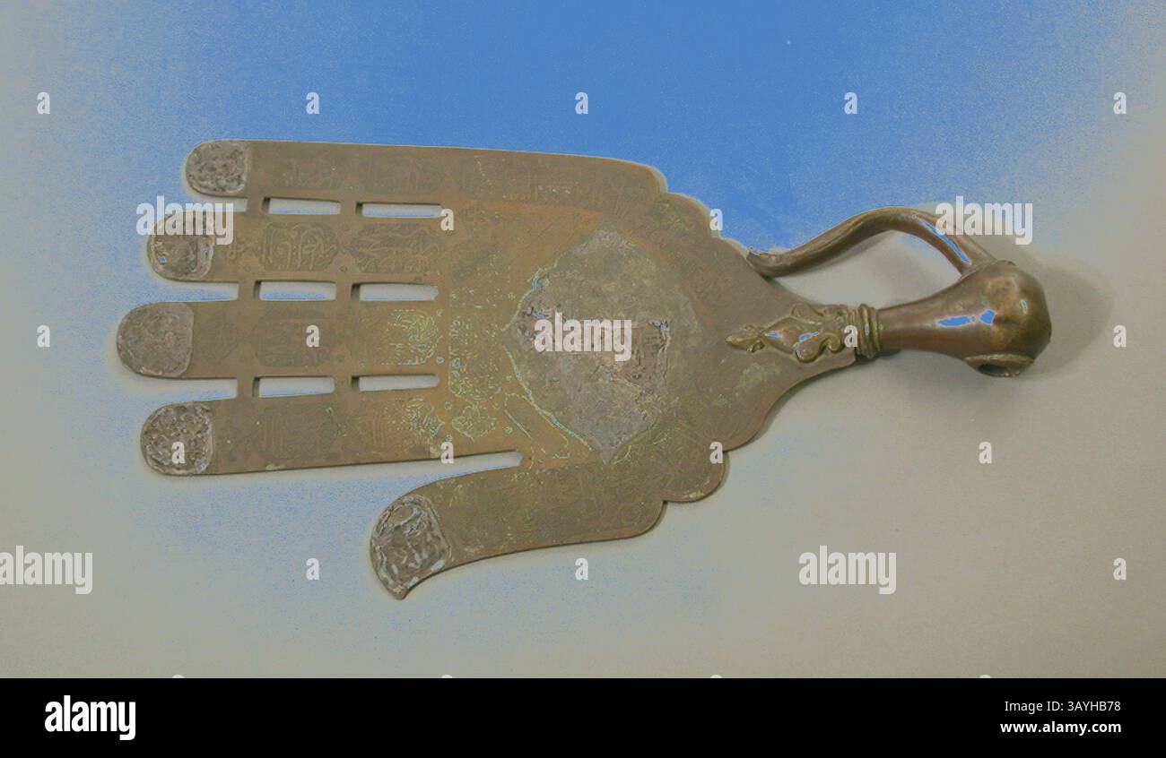 An ornate hand-shaped object featuring intricate designs and symbols ...