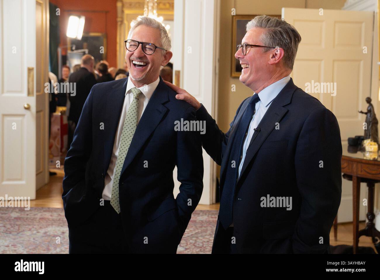 Britain's Prime Minister Keir Starmer, right, laughs with Gary Lineker ...